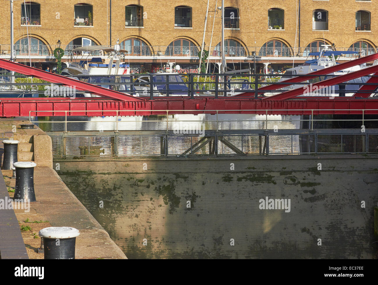 Bridge across lock linking luxury marina St Katherine Docks to river ...