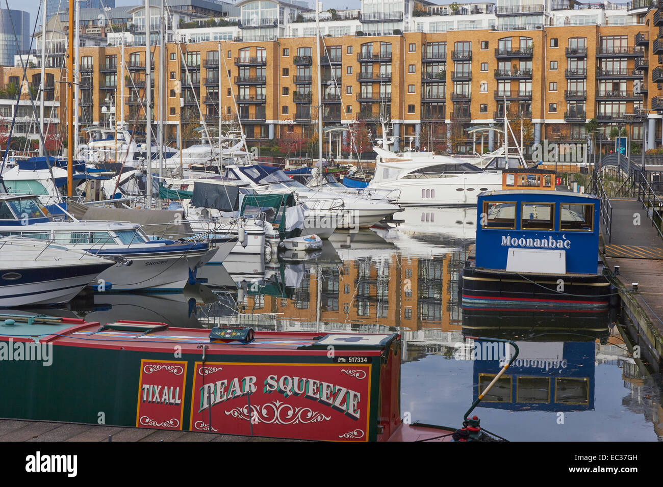 Boats barges and yachts moored in luxury St Katherine Docks marina east ...
