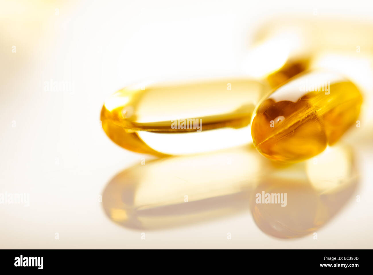 shiny yellow vitamin e fish oil capsule on white background Stock Photo ...
