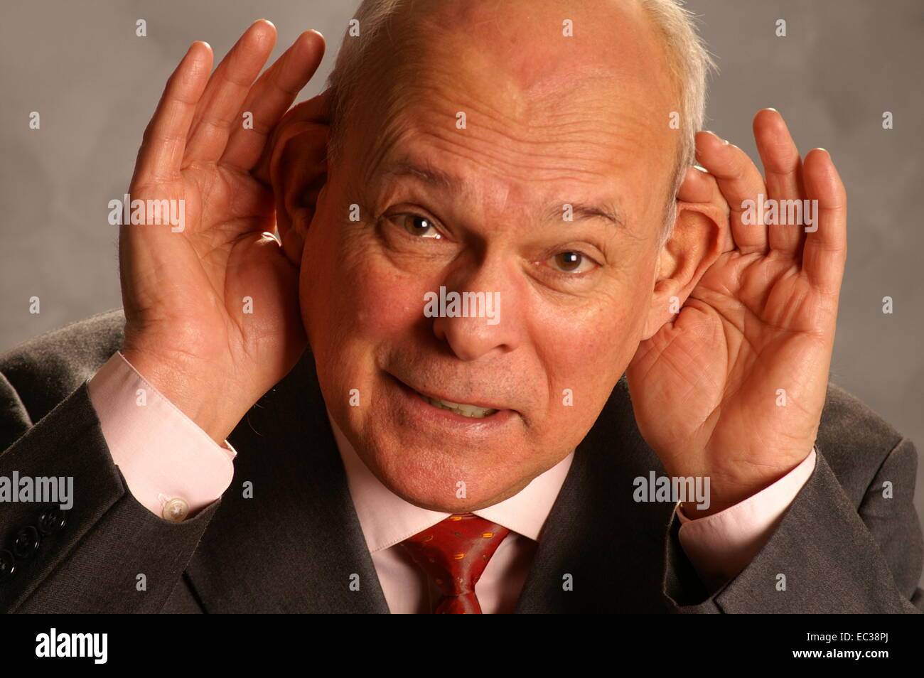 senior man trying to hear with hands by ears Stock Photo - Alamy