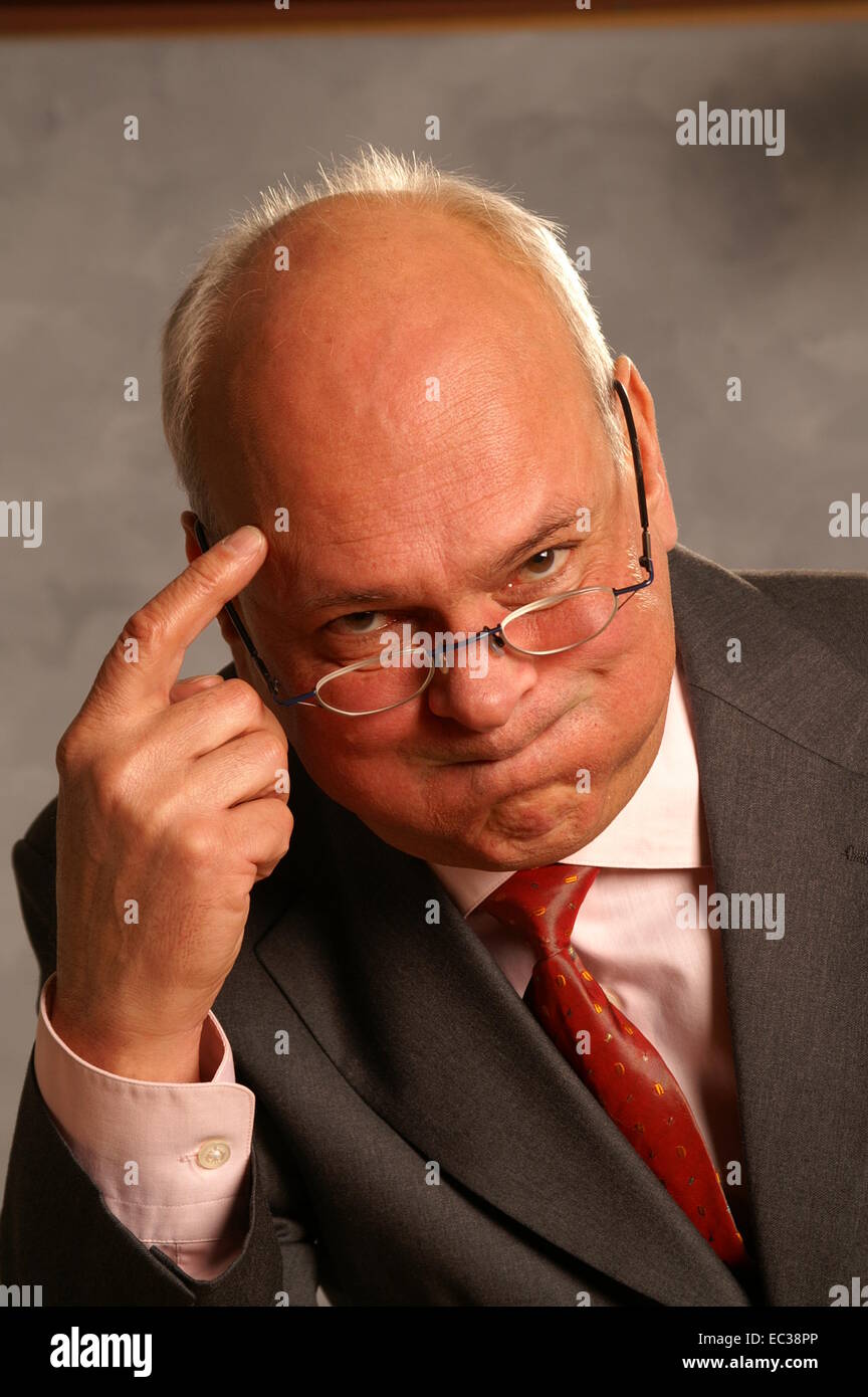 elderly man pointing to his forehead Stock Photo - Alamy