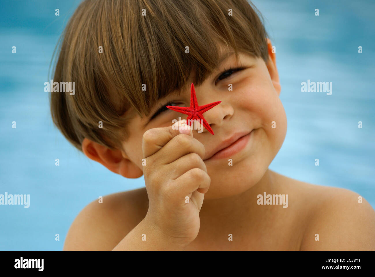 Little Boy with Starfish on the Sea Stock Photo - Alamy