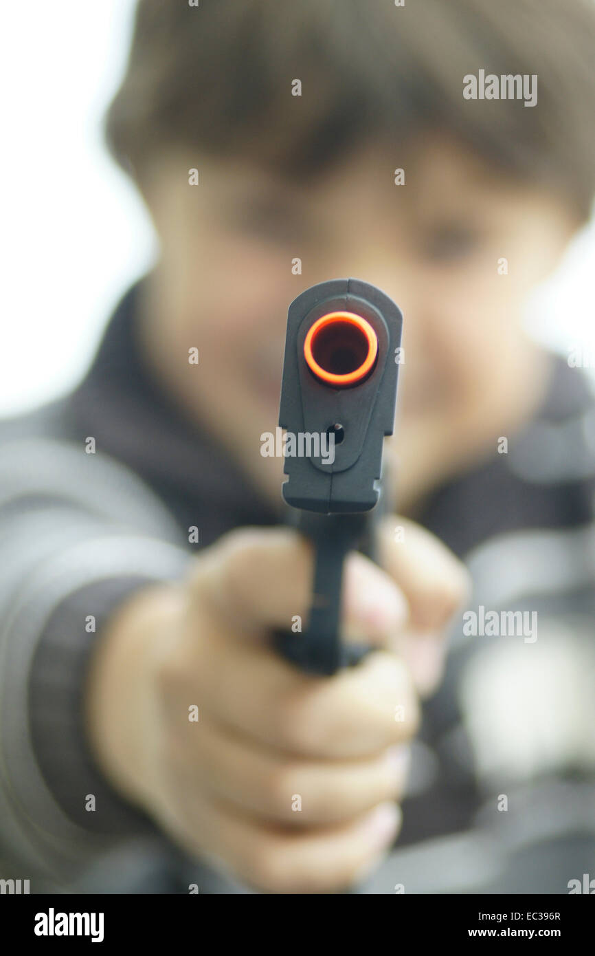 Little boy with toy gun Stock Photo - Alamy