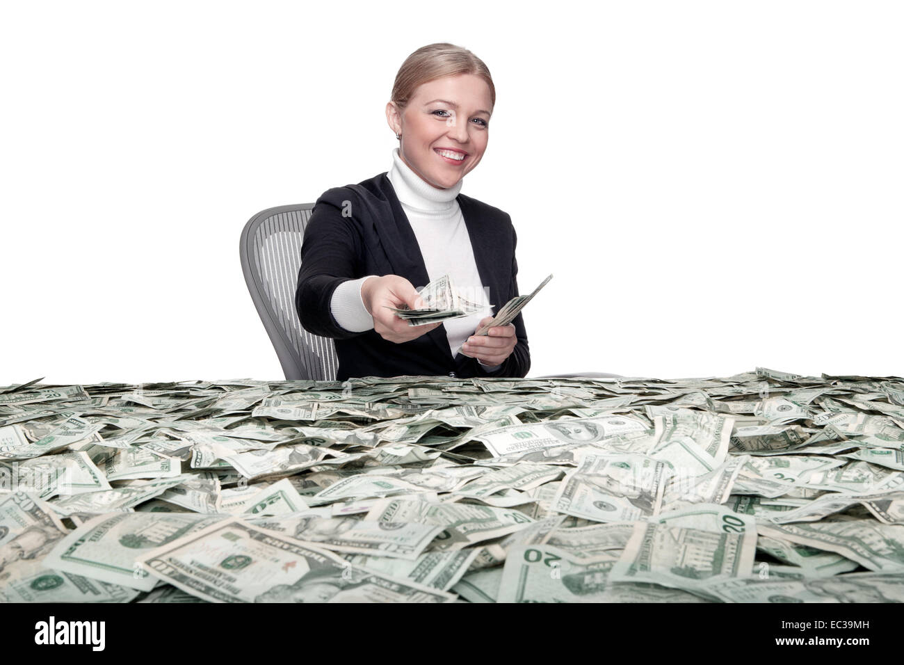 portrait of young woman sitting behind the table full of cash Stock ...