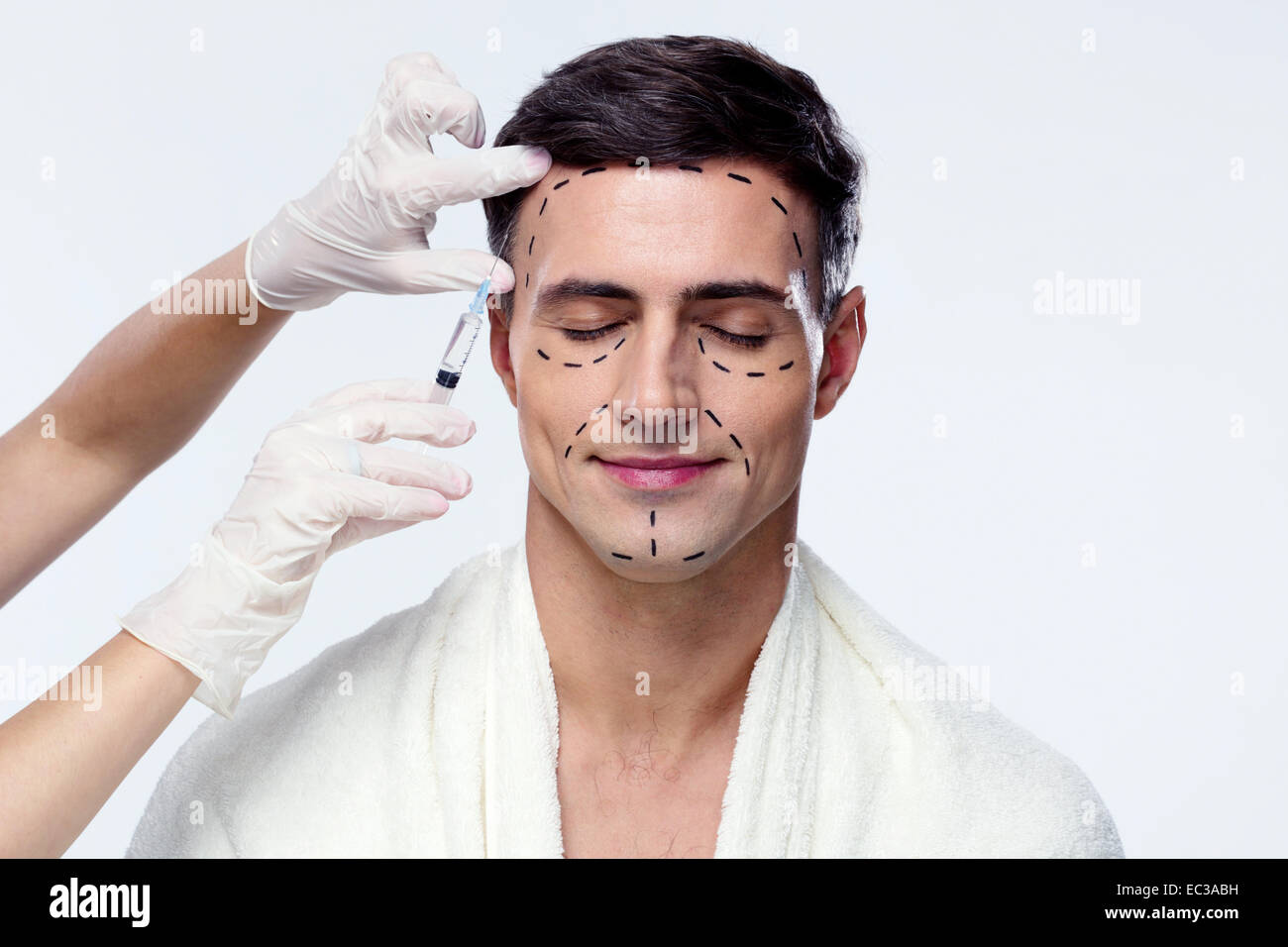 Man with closed eyes at plastic surgery with syringe in his face Stock ...