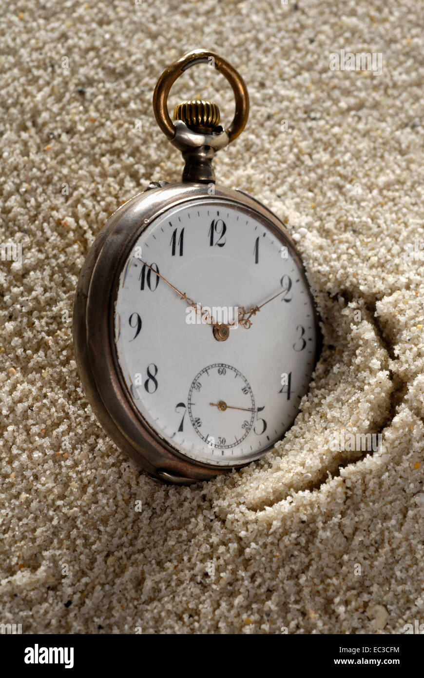 Old Pocket Clock in Sand Stock Photo - Alamy