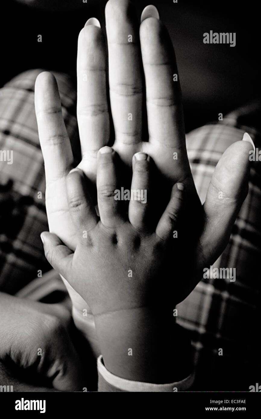 Big and small hand Stock Photo - Alamy