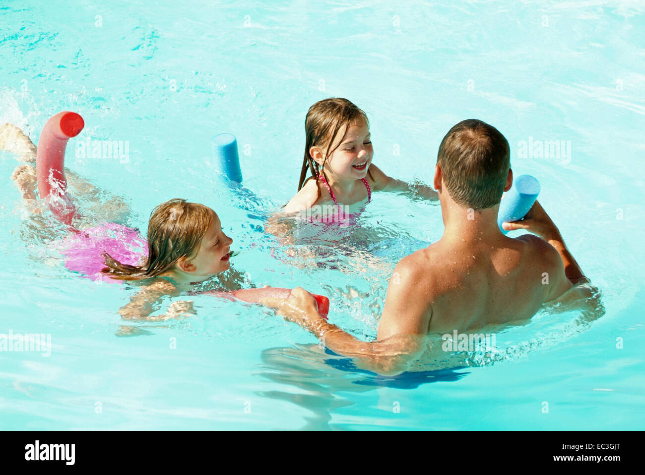 Father with Daughters in Pool Stock Photo - Alamy