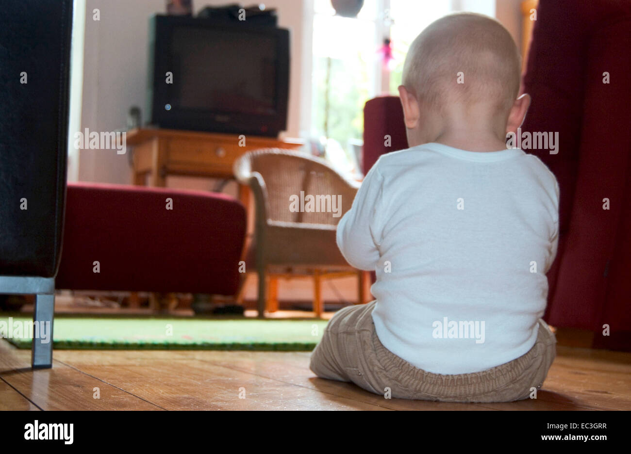 Lonely Baby in Living Room Stock Photo - Alamy