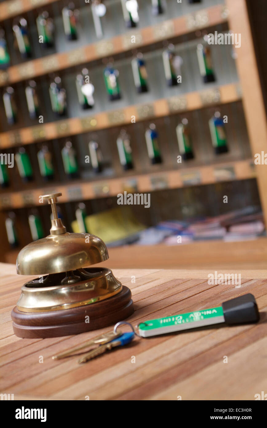 Bell and Room Key on a Reception Desk in a Hotel Stock Photo - Alamy