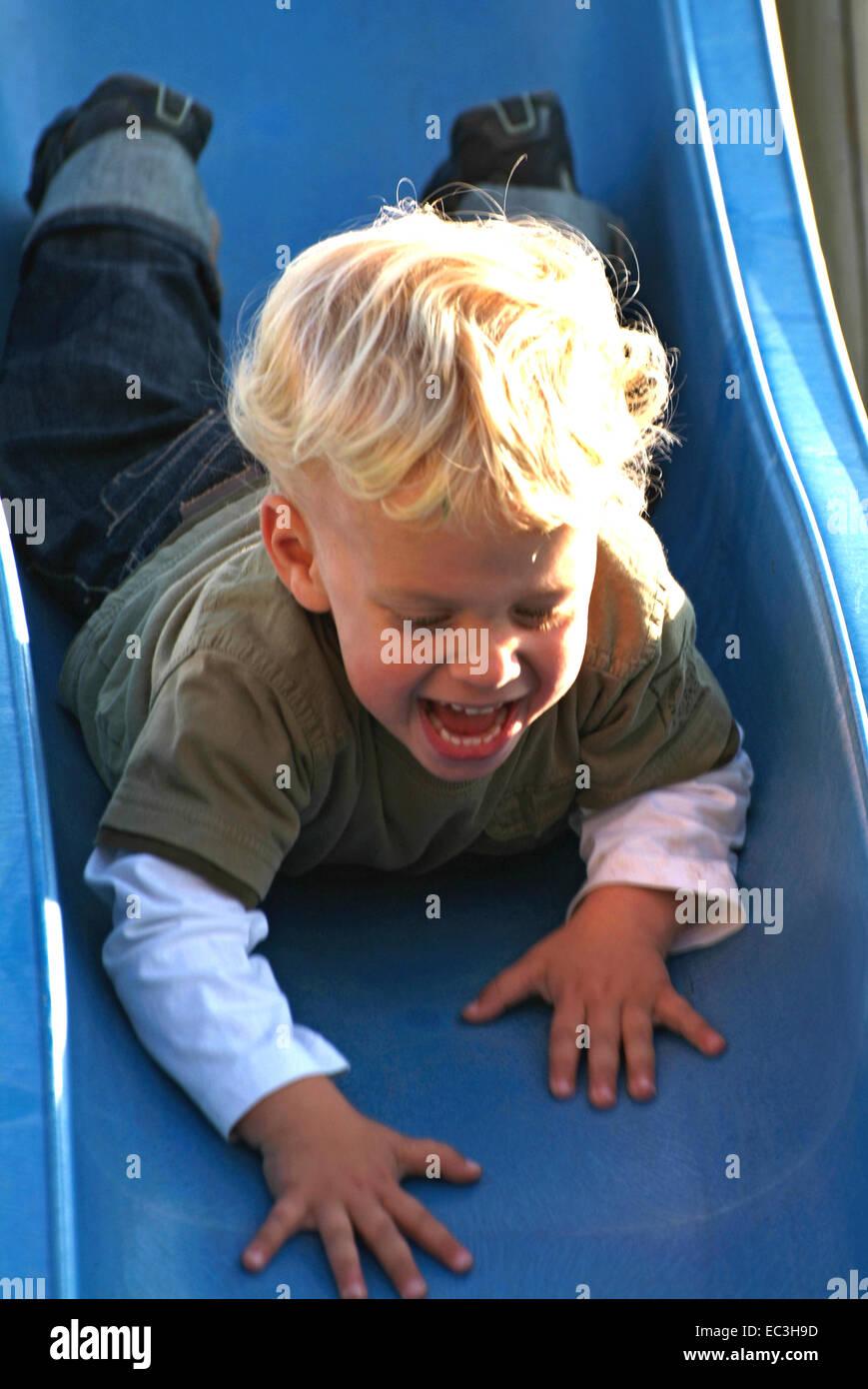 Boy on a Slide Stock Photo - Alamy