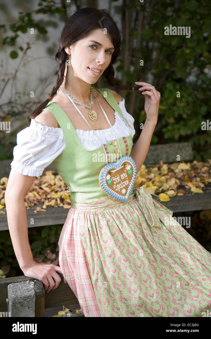 Woman wearing a Dirndl with a Gingerbread Heart Stock Photo - Alamy