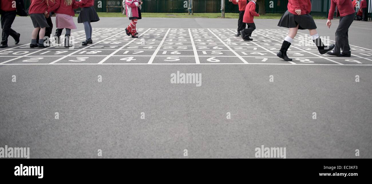 British schoolchildren playing hopscotch in a playground Stock Photo ...