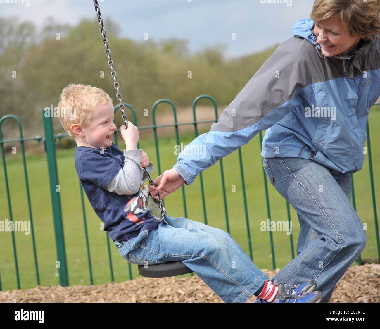 A mother pulls her young child along a zip line Stock Photo - Alamy