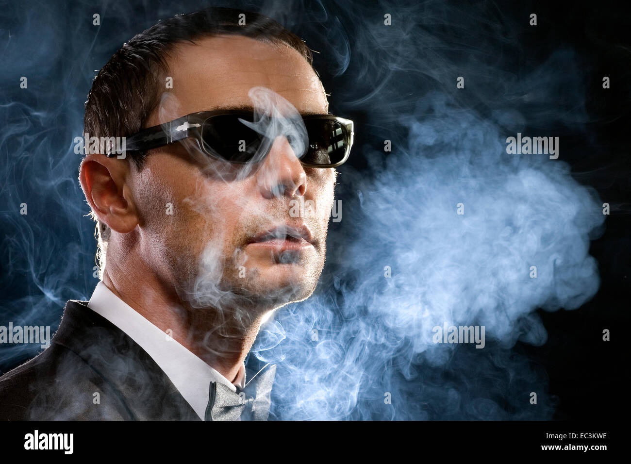 Man with Sun Glasses in Cloud of Smoke Stock Photo - Alamy