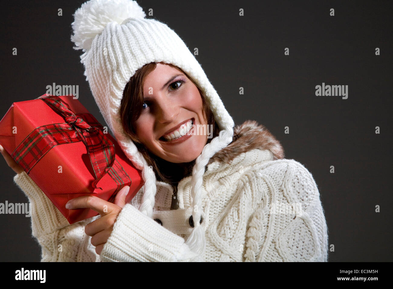 Woman in Winter Clothes with Present Stock Photo - Alamy