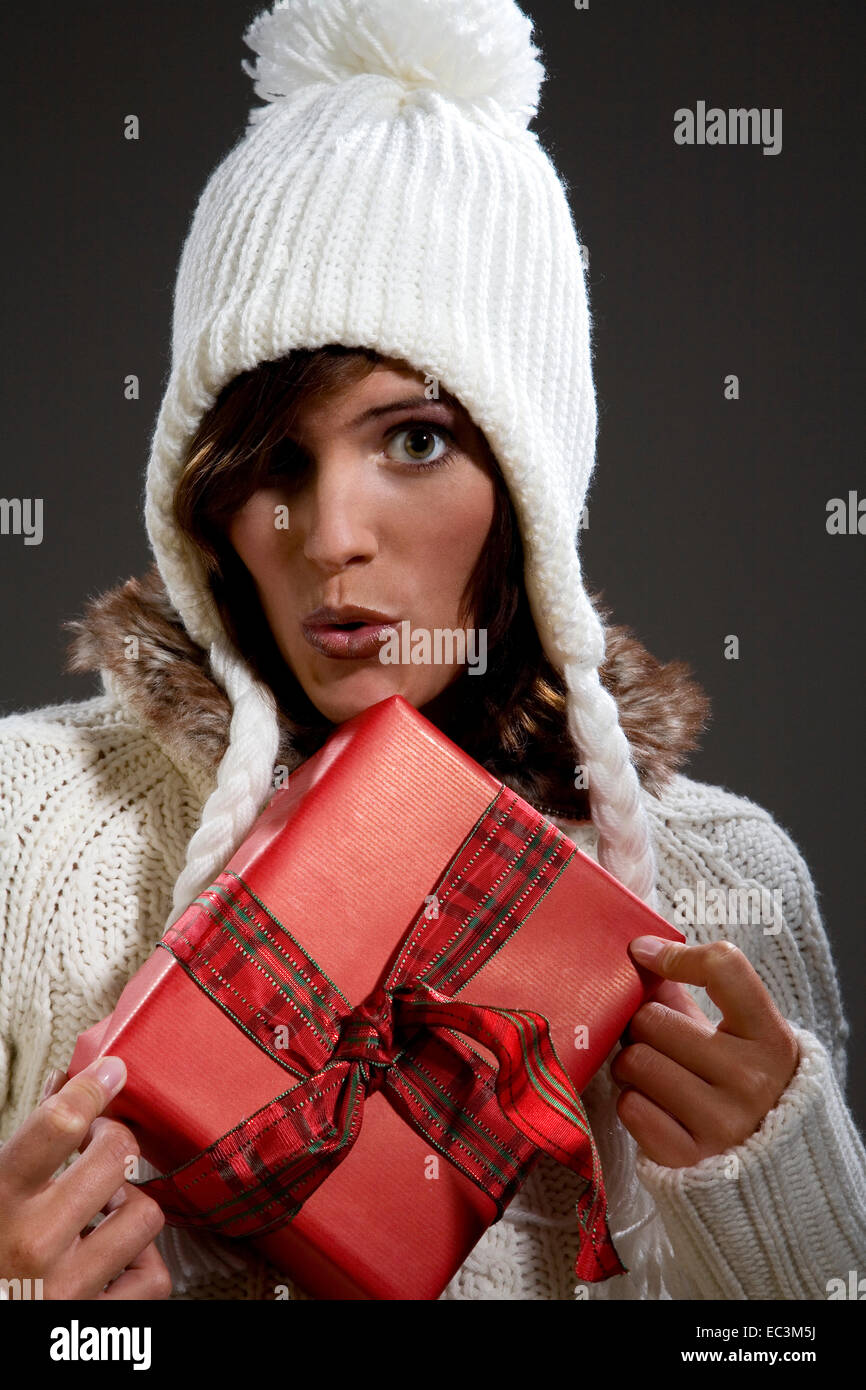 Woman in Winter Clothes with Present Stock Photo - Alamy