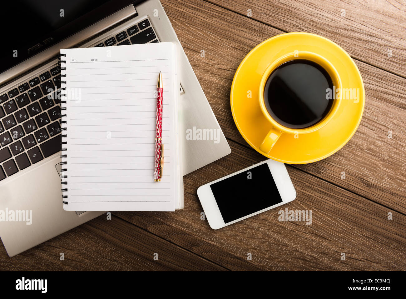 Office desk with laptop computer, notebook, mobile smartphone and ...