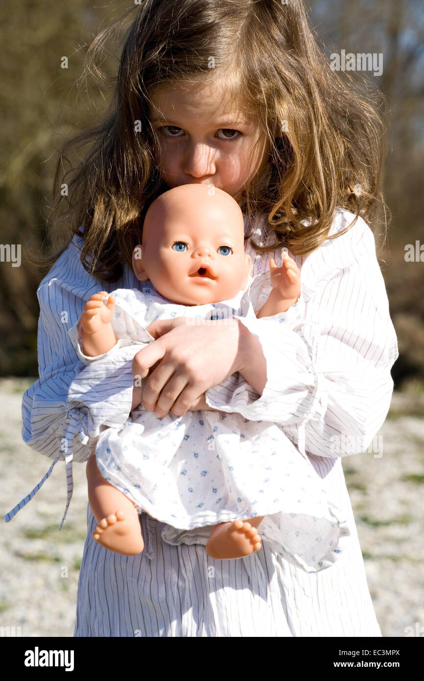 Girl holding her Doll in her Arms Stock Photo - Alamy