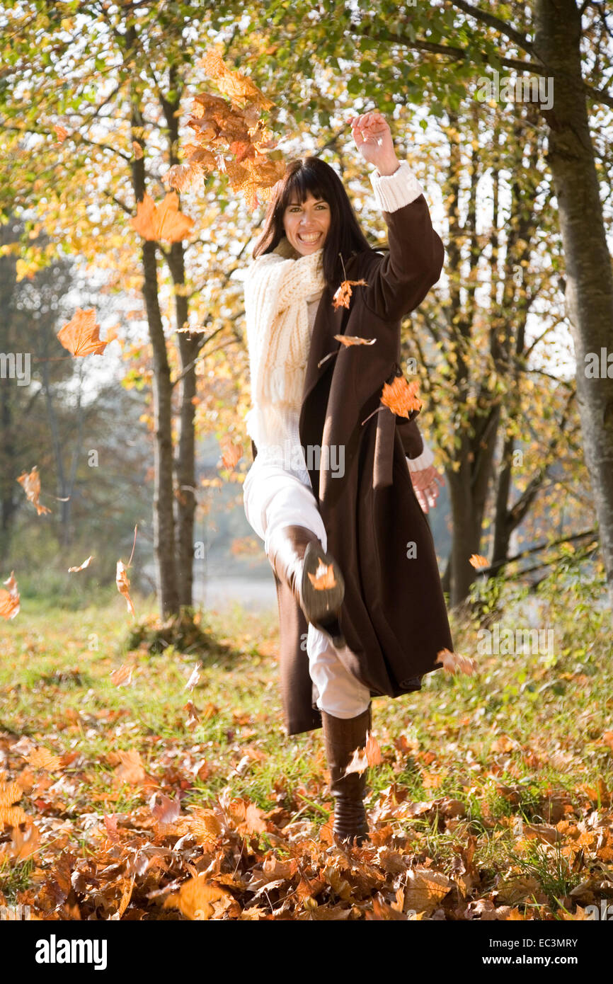 Woman raising leaves in a Forest Stock Photo - Alamy