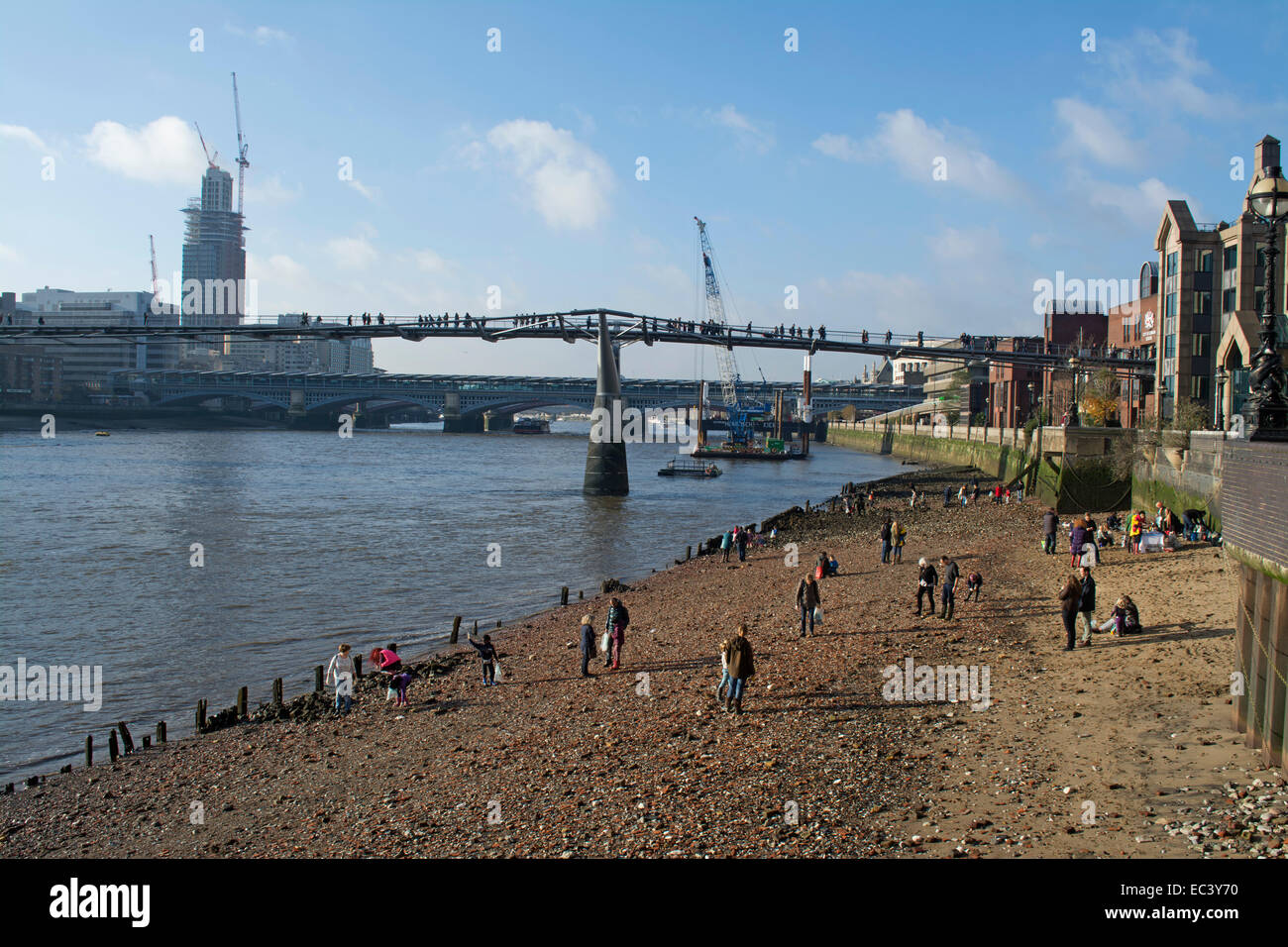 Beachcombers on the North Bank of the River Thames underneath the ...