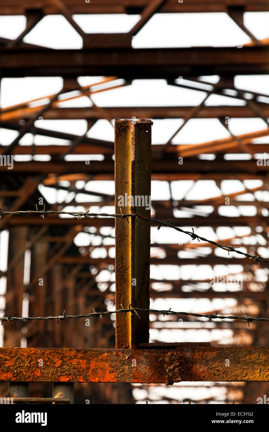 rusty iron girders with barbed wire Stock Photo - Alamy