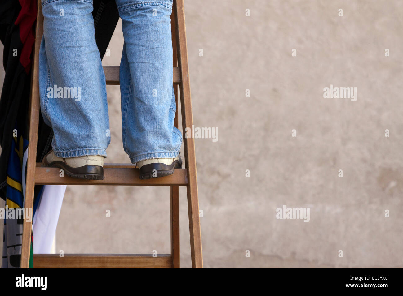 Man stands on a wooden ladder Stock Photo - Alamy