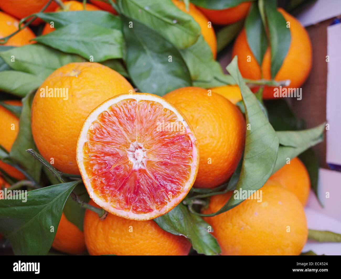 Sliced Sicilian blood red orange with leaf Stock Photo - Alamy
