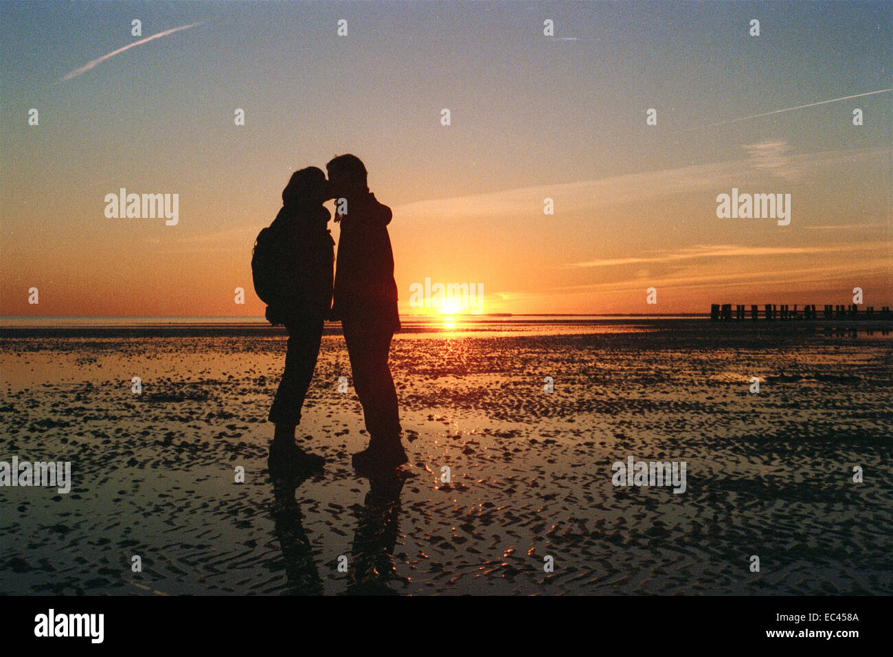Couple kissing in Sunset Stock Photo - Alamy