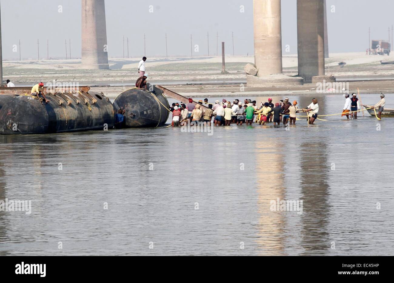 Laborers constructing temporary pontoon bridge on the river Ganga ahead ...