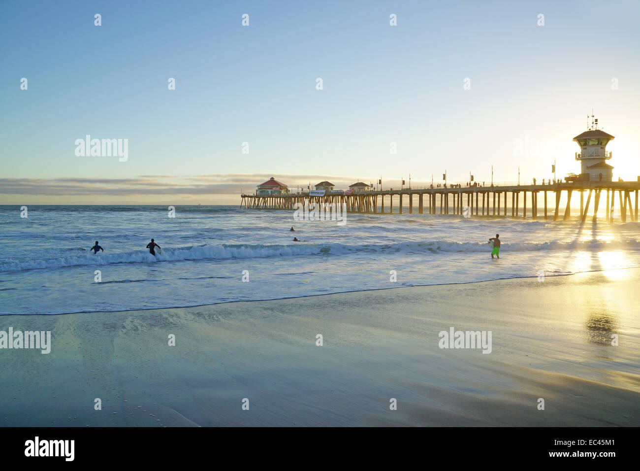 Surfers at Huntington Beach Pier Stock Photo - Alamy
