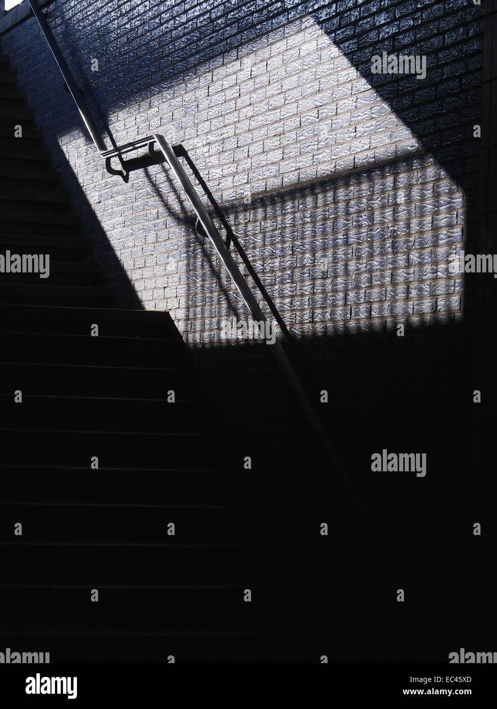 Underpass showcases shiny brick walls as sun light rests on its wall ...