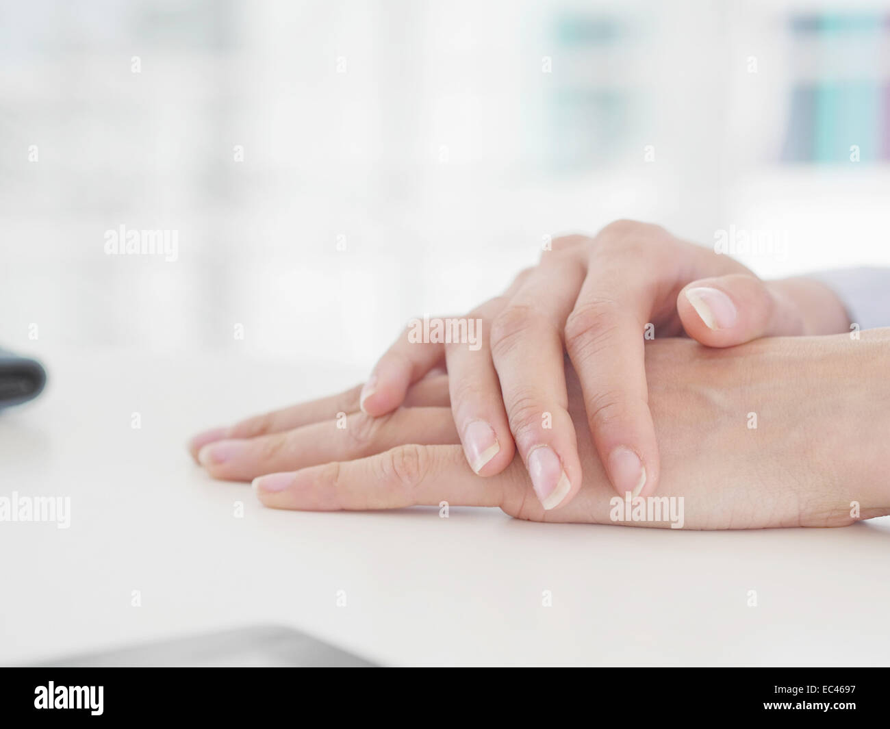 Woman hands with woman hands resting table Stock Photo - Alamy