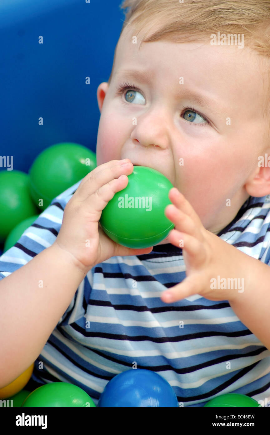 Child with Ball in her Mouth Stock Photo - Alamy