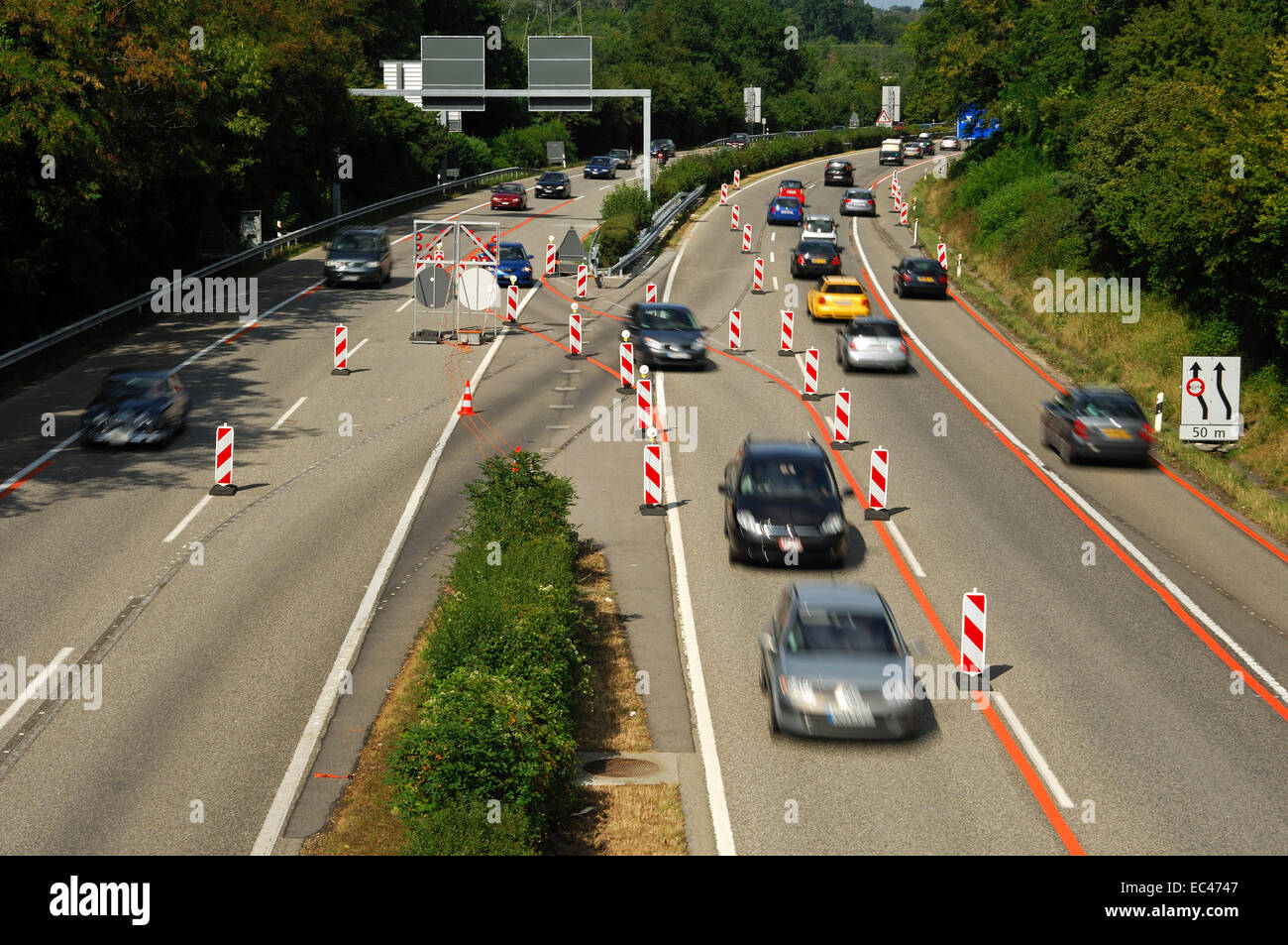 Motion-blurred vehicles on a highway in road narrowing segment Stock ...