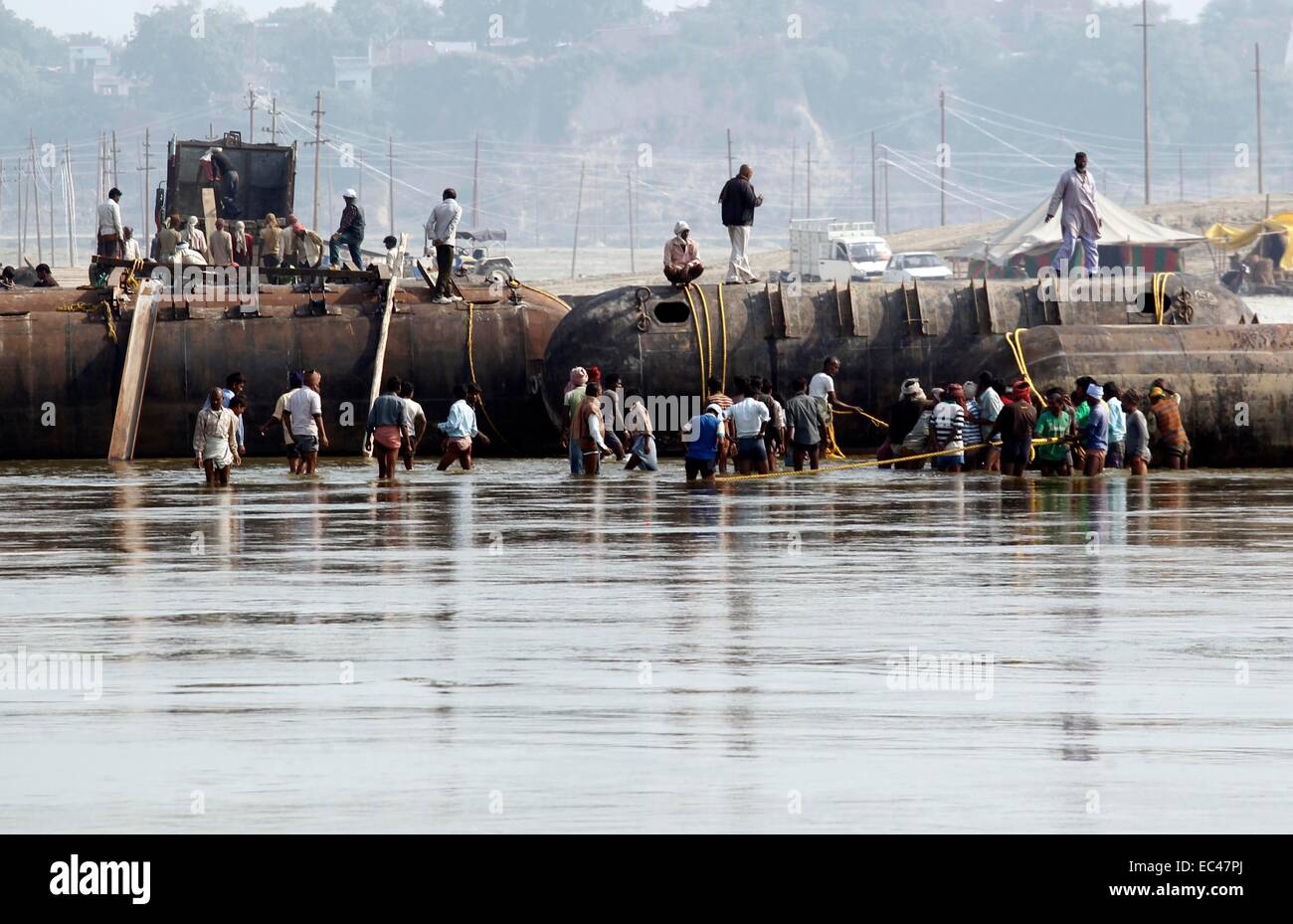 Laborers constructing temporary pontoon bridge on the river Ganga ahead ...