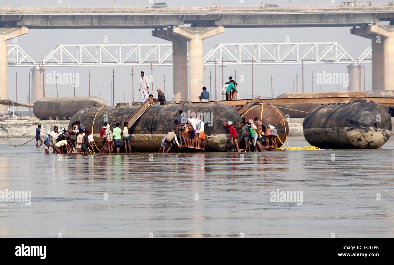 Laborers constructing temporary pontoon bridge on the river Ganga ahead ...