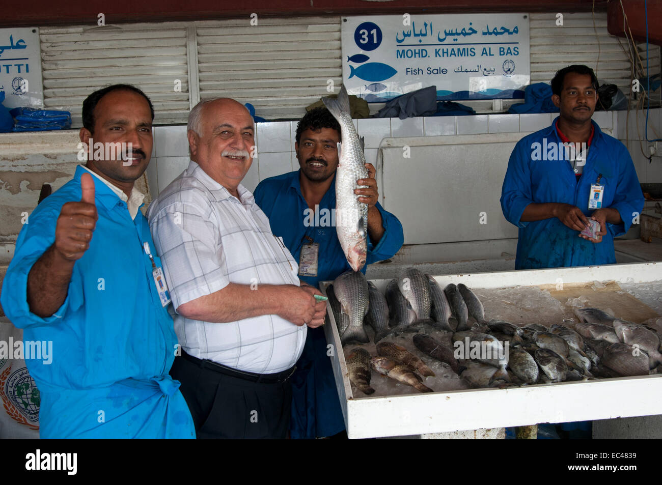 Fish mongers with fresh fish at the fish market in Sharjah, United Arab ...