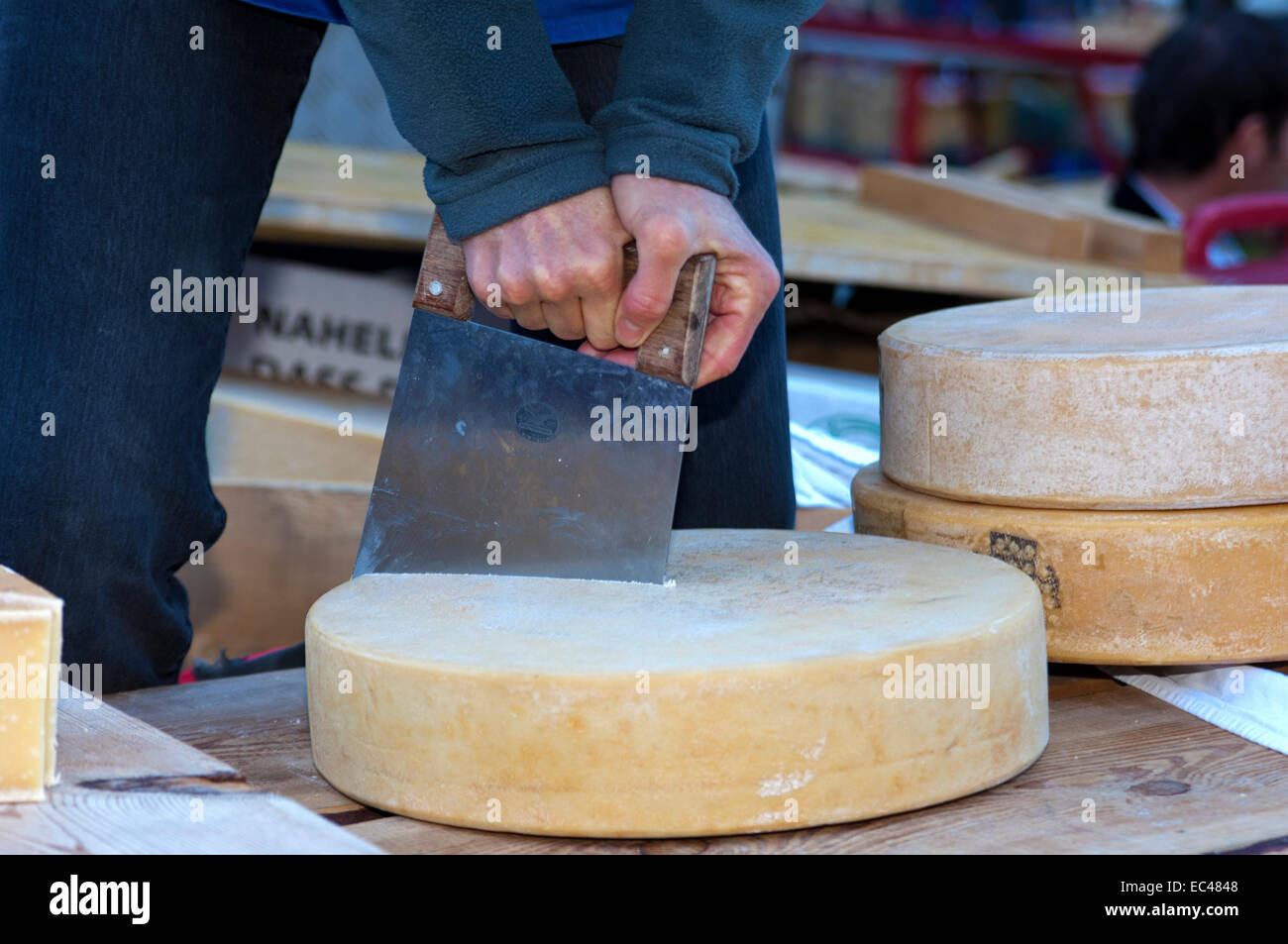 Cutting of a round Swiss alpine cheese truckle, Switzerland Stock Photo ...