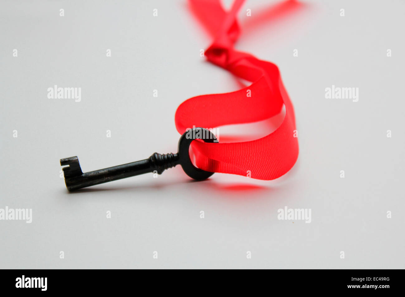 Key on a red ribbon Stock Photo - Alamy