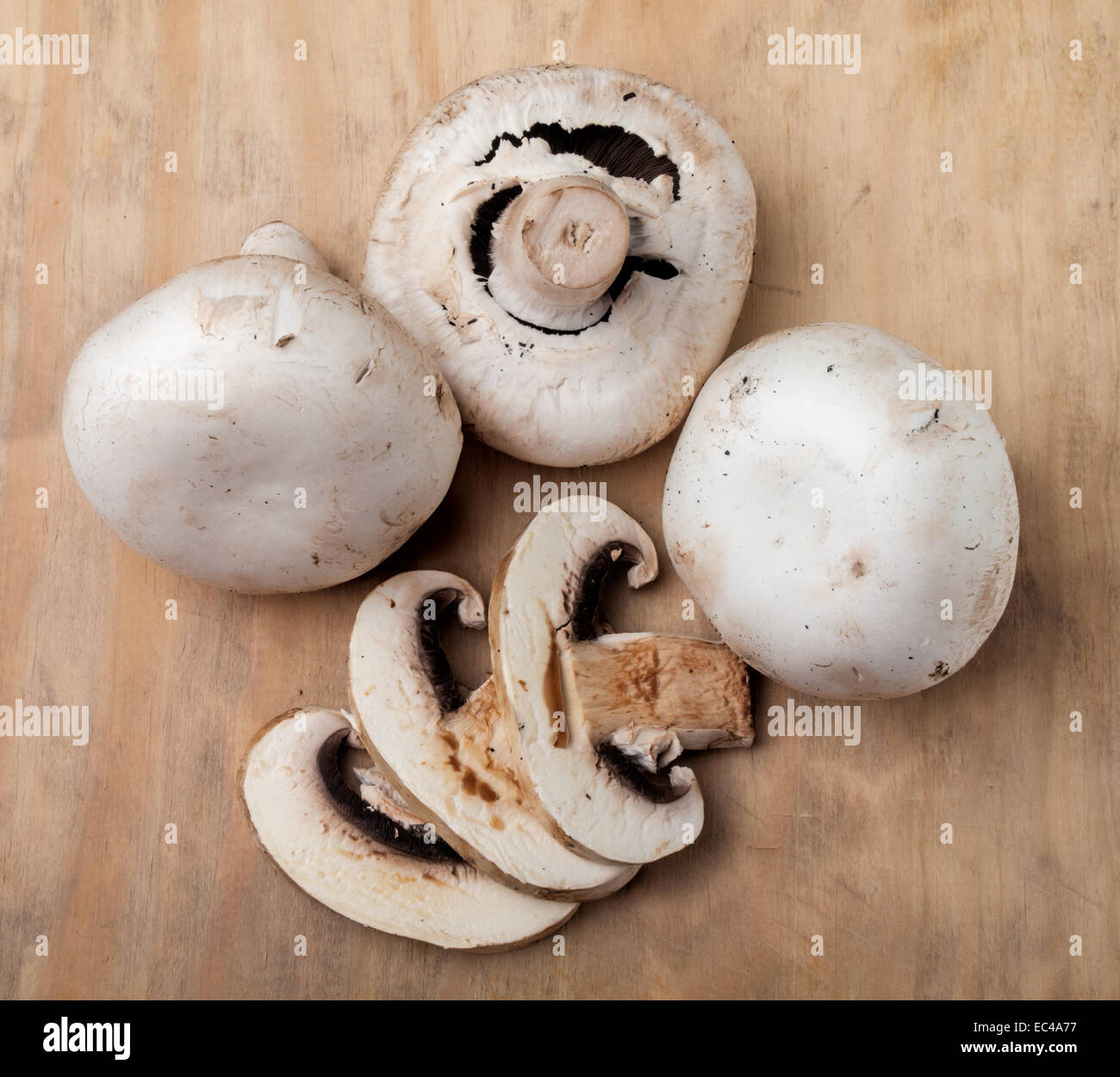 whole and sliced champignon mushrooms on wood Stock Photo - Alamy