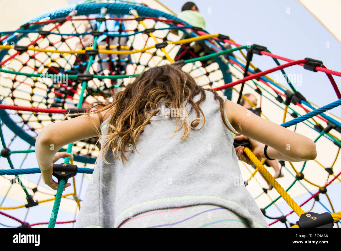 Young girl back to camera plays in the playground Stock Photo - Alamy