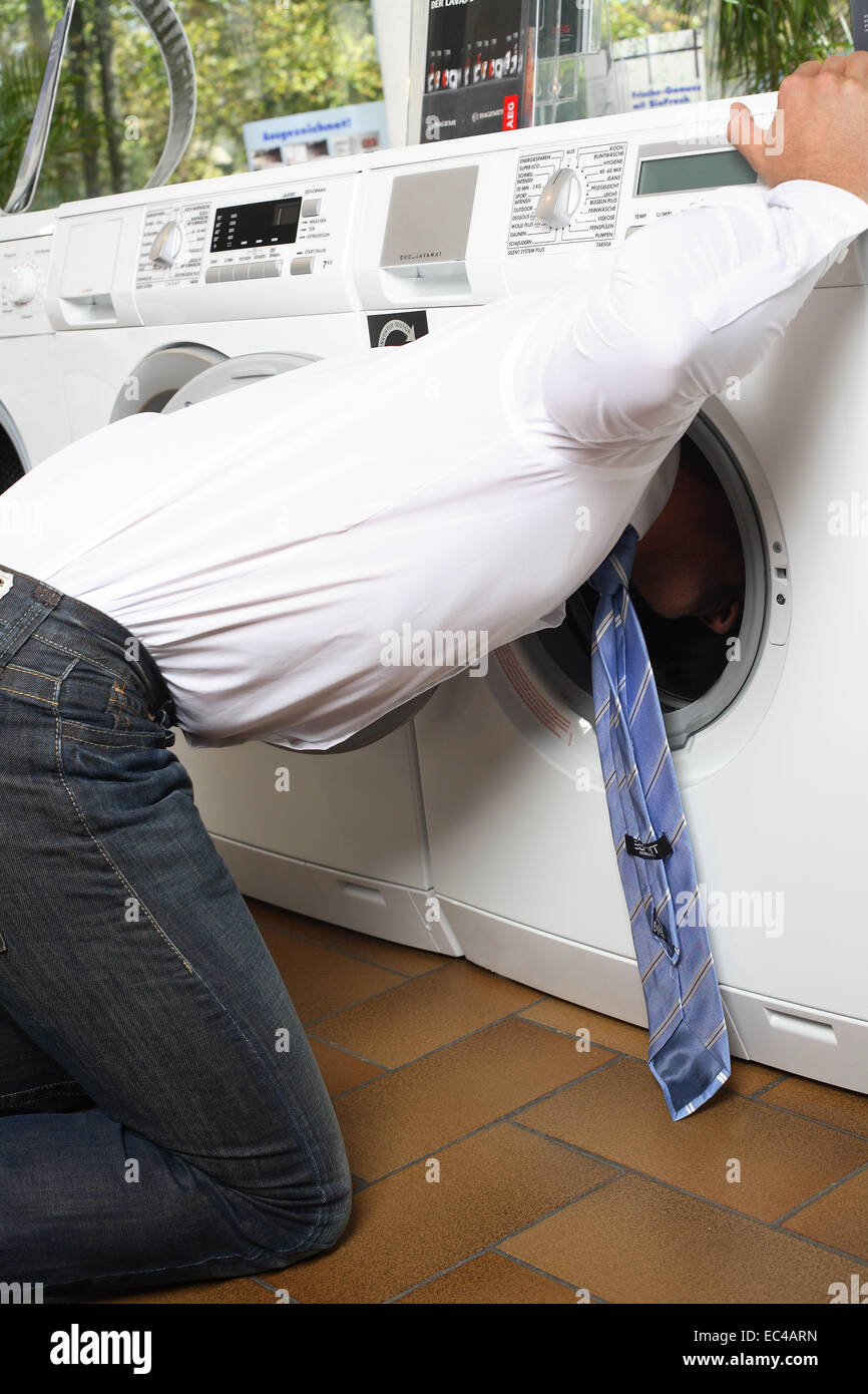 Clothes Washer Salesman Sticking his Head in Washing Machine Stock ...