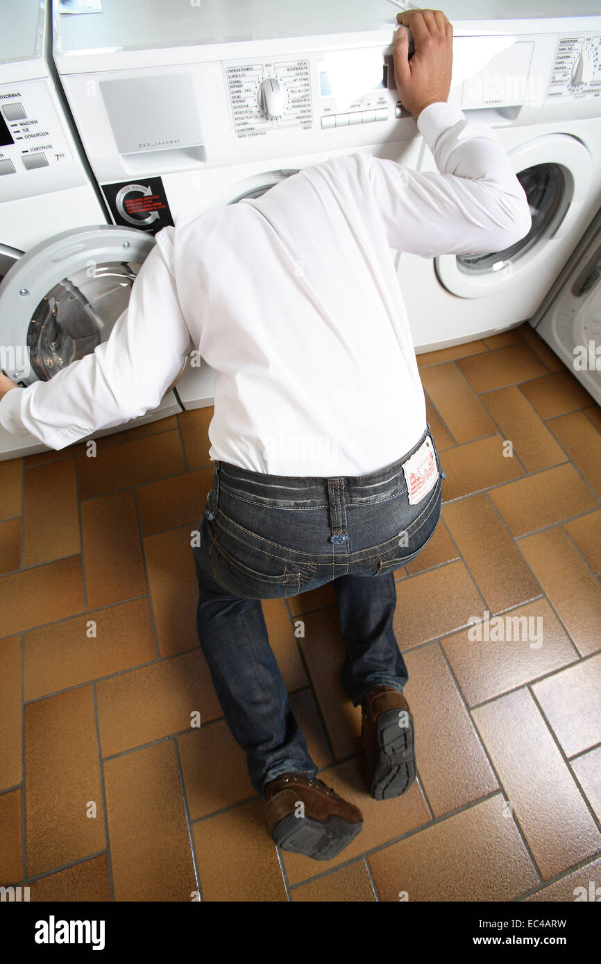 Clothes Washer Salesman Sticking his Head in Washing Machine Stock ...