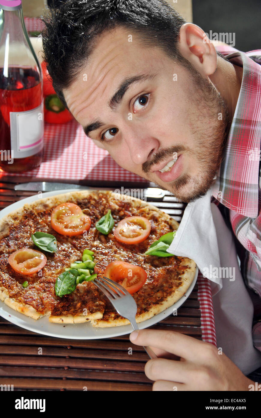 Crazy hungry man eating pizza in a restaurant Stock Photo - Alamy