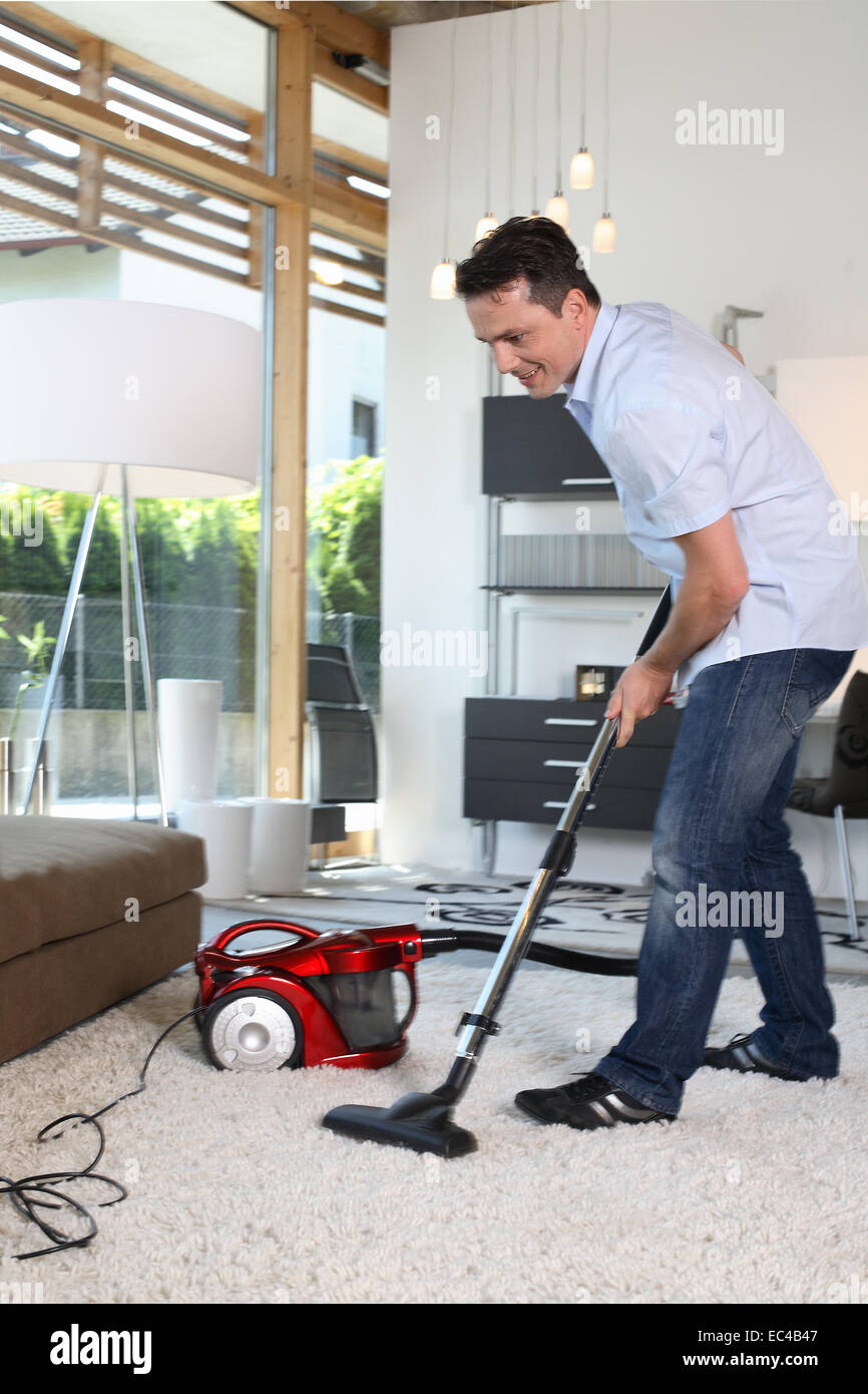 Man Cleaning with a Vacuum Cleaner Stock Photo - Alamy