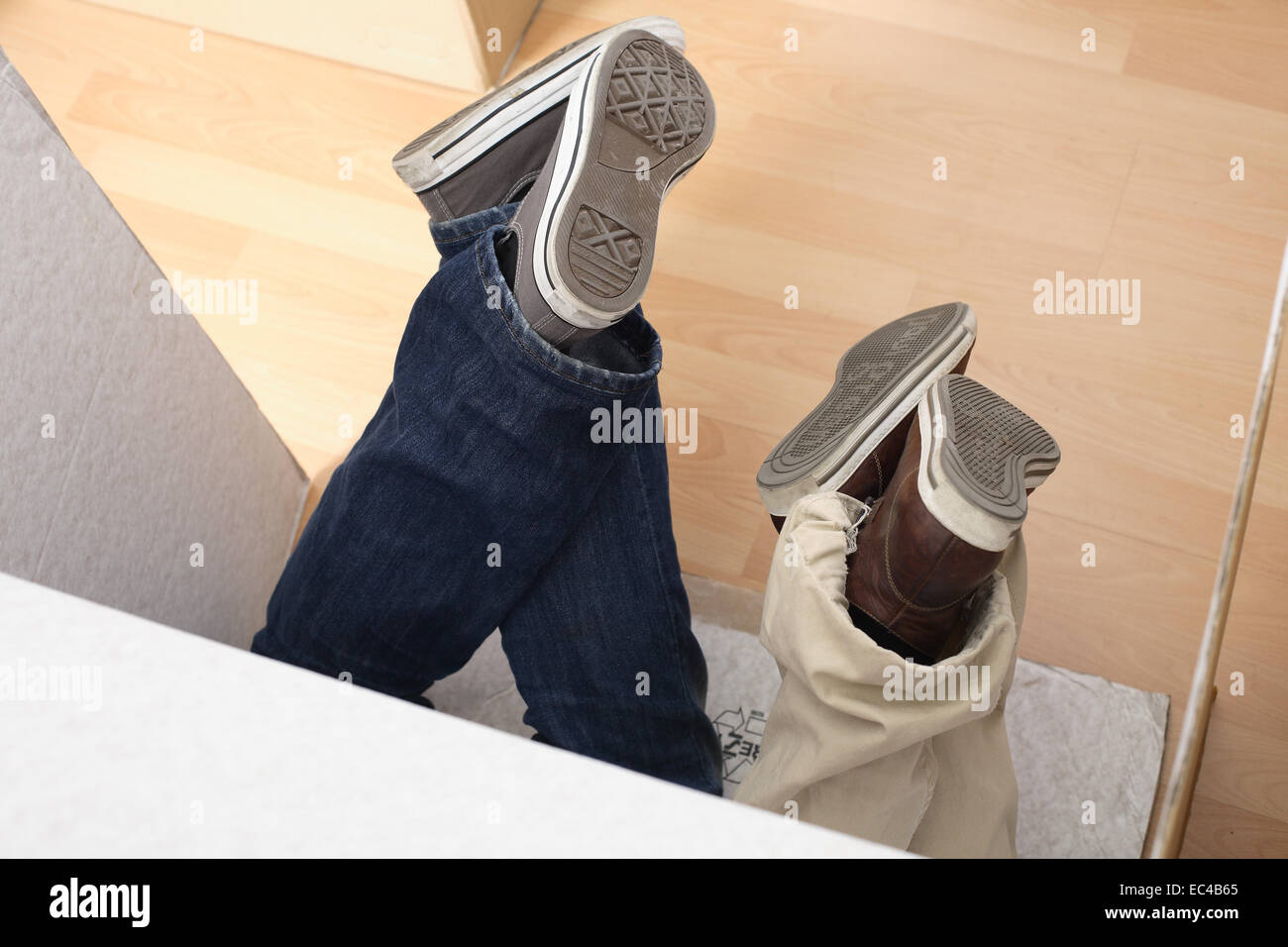 Feet Protruding from a moving box Stock Photo - Alamy