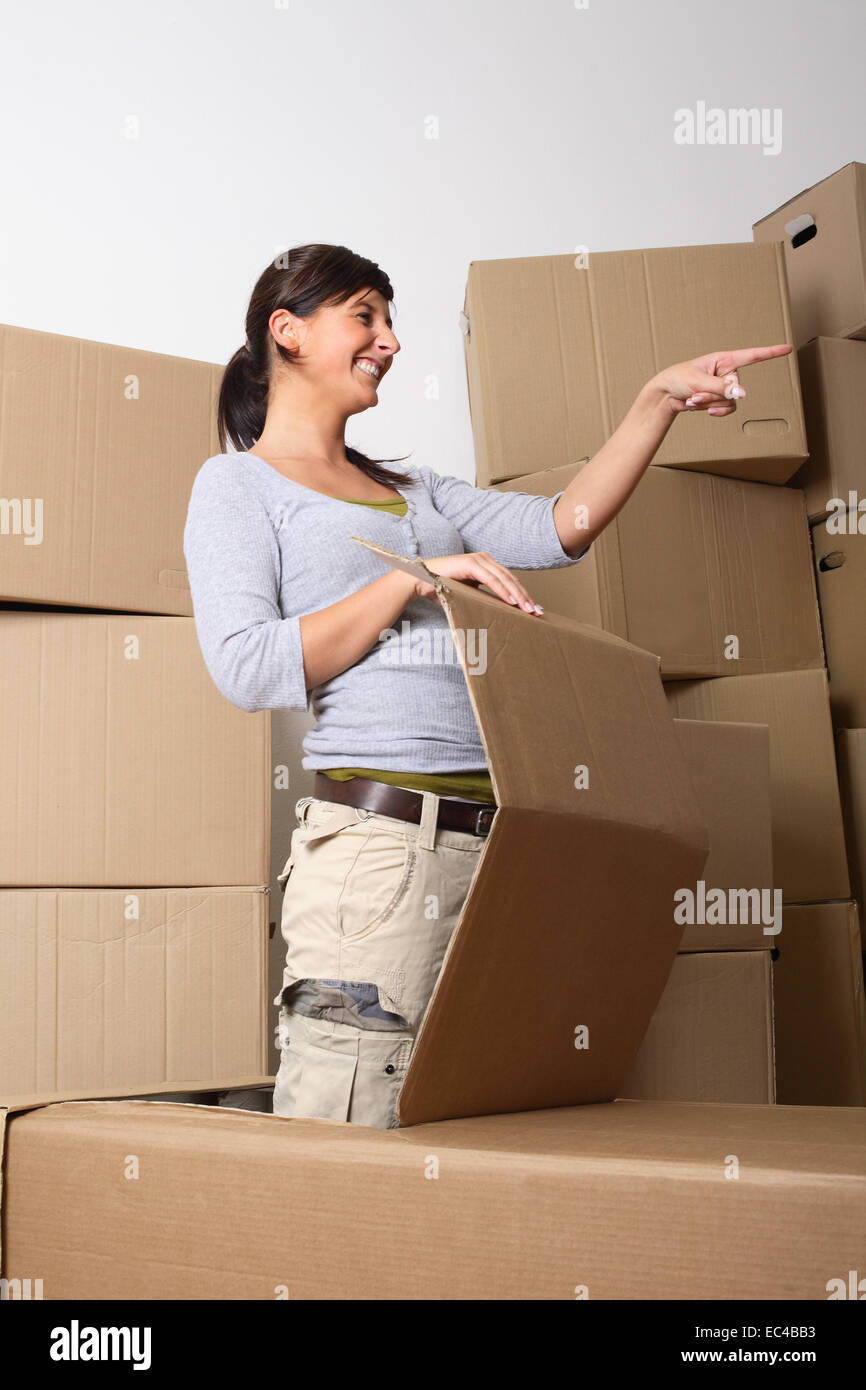 Young Woman standing in Moving Box Stock Photo - Alamy