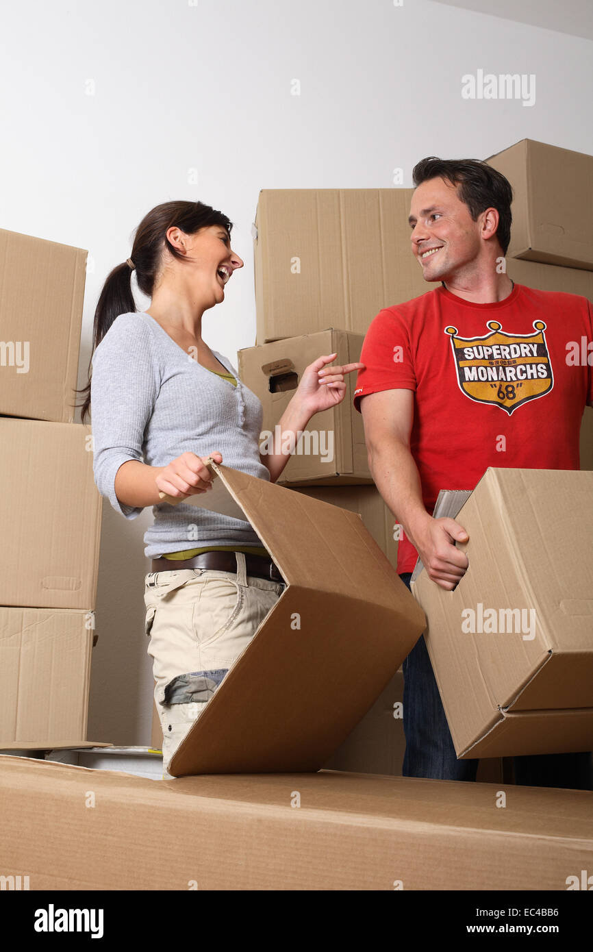 Woman with cardboards with the move in the new flat hi-res stock ...