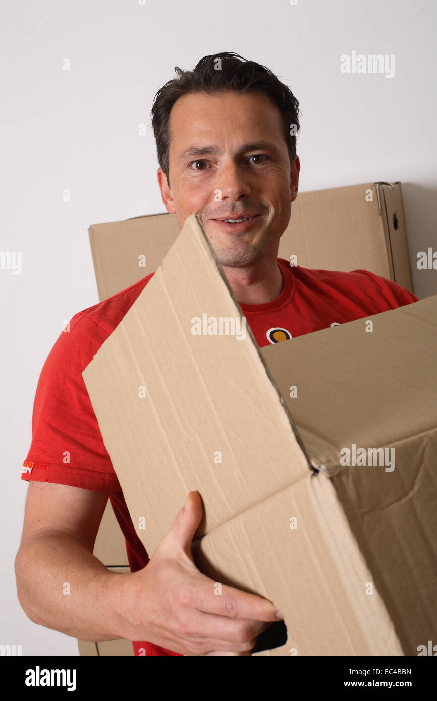 Man Moving Home, Bearing Open Packing Case Stock Photo - Alamy